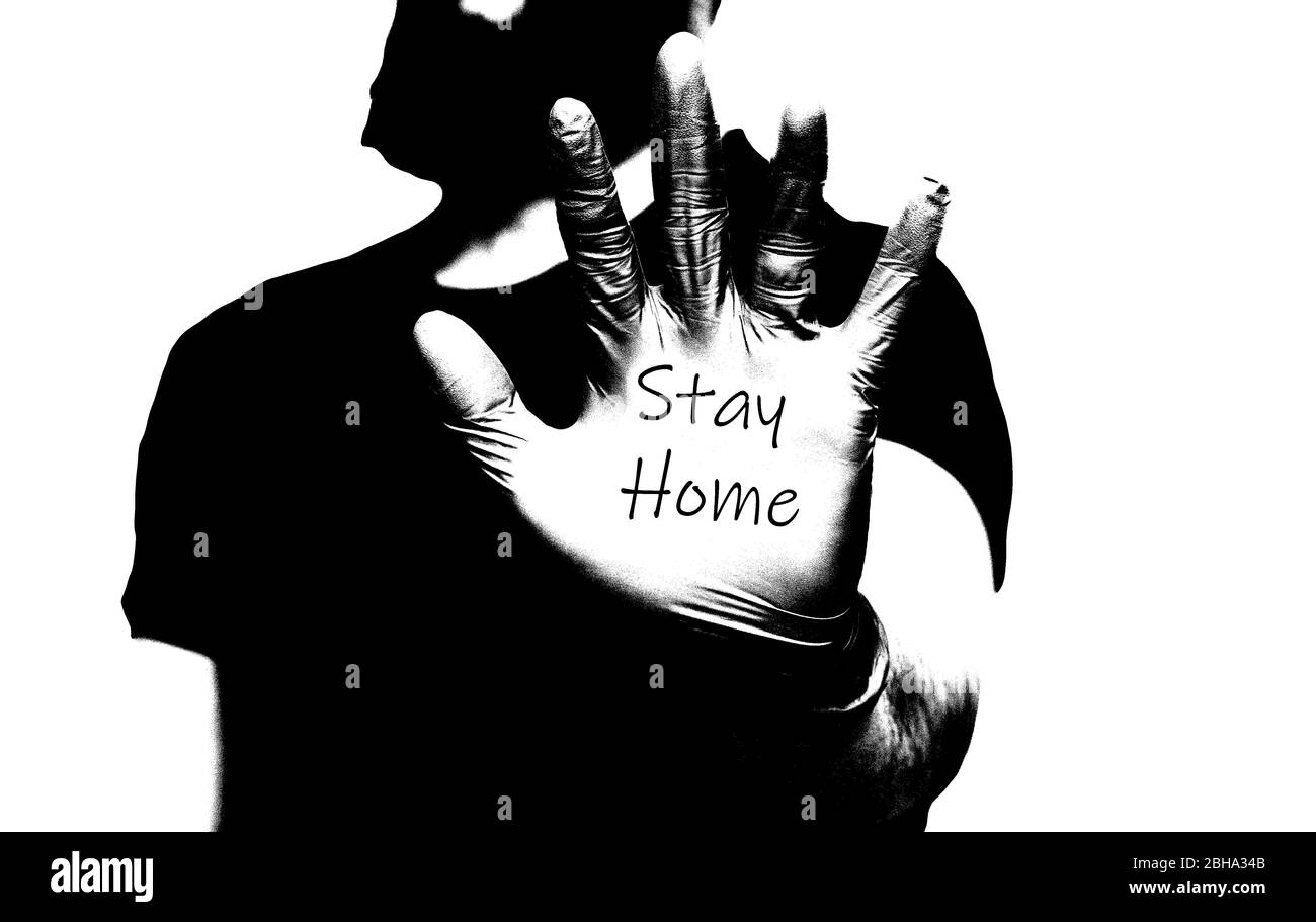 Man's hand in blue medical gloves with the words Stay Home, self ...