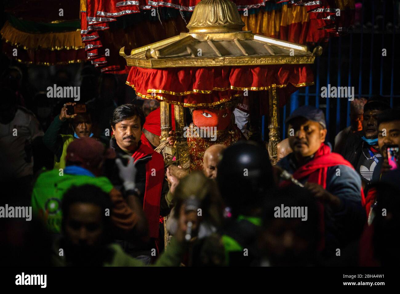 Priests carry an idol of deity Rato (Red) Machindranath in a chariot ...