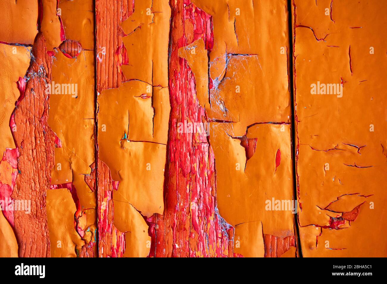 Color on wood chipped and weathered red orange yellow Stock Photo - Alamy