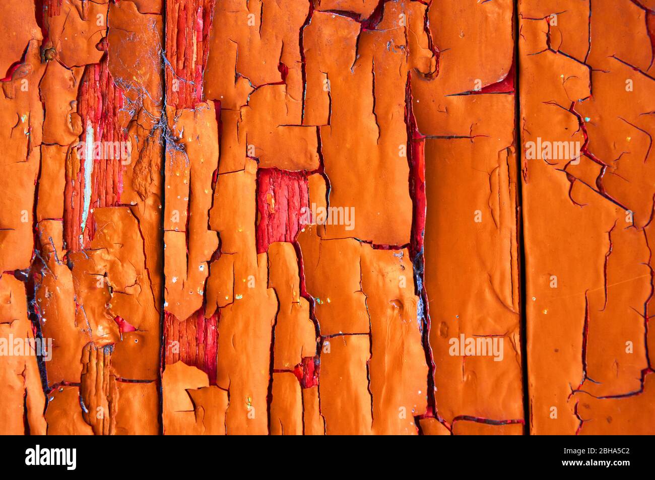 Color on wood chipped and weathered red orange yellow Stock Photo - Alamy