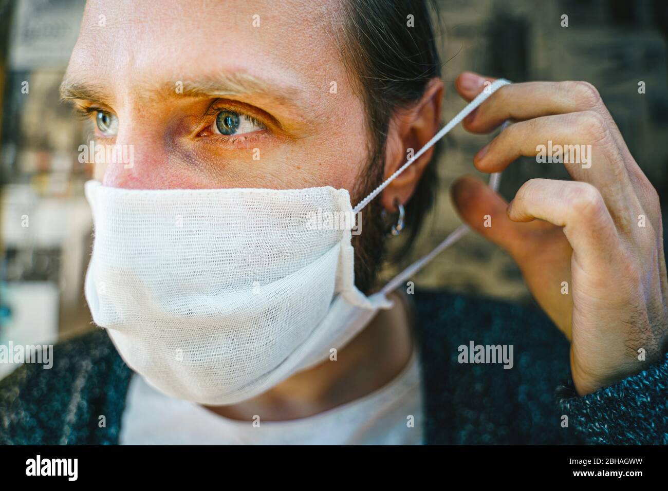 Man puts on mask before hi-res stock photography and images - Alamy