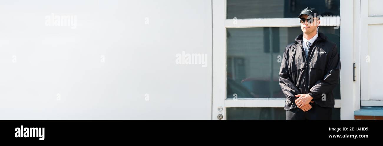 Security Guard Agent Standing At Door Entrance Stock Photo - Alamy