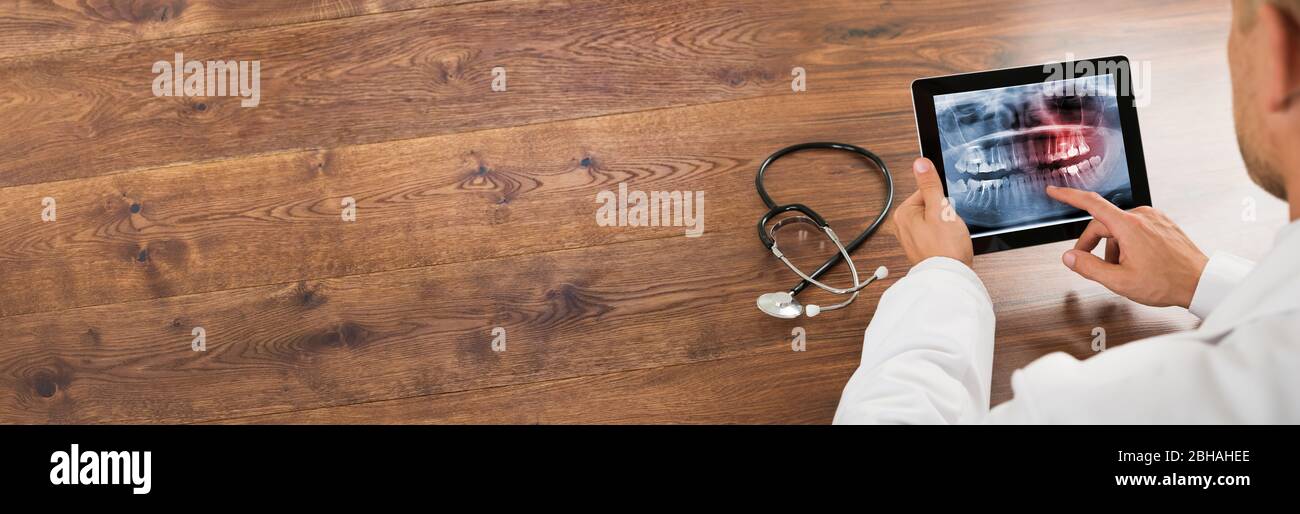 Dentist Doctor Looking At Jaw Tooth Dental Xray Stock Photo - Alamy
