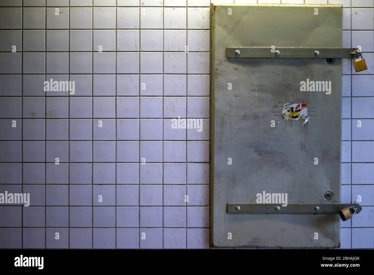 Locked metal flap for compartment in tiled station tunnel hi-res stock ...