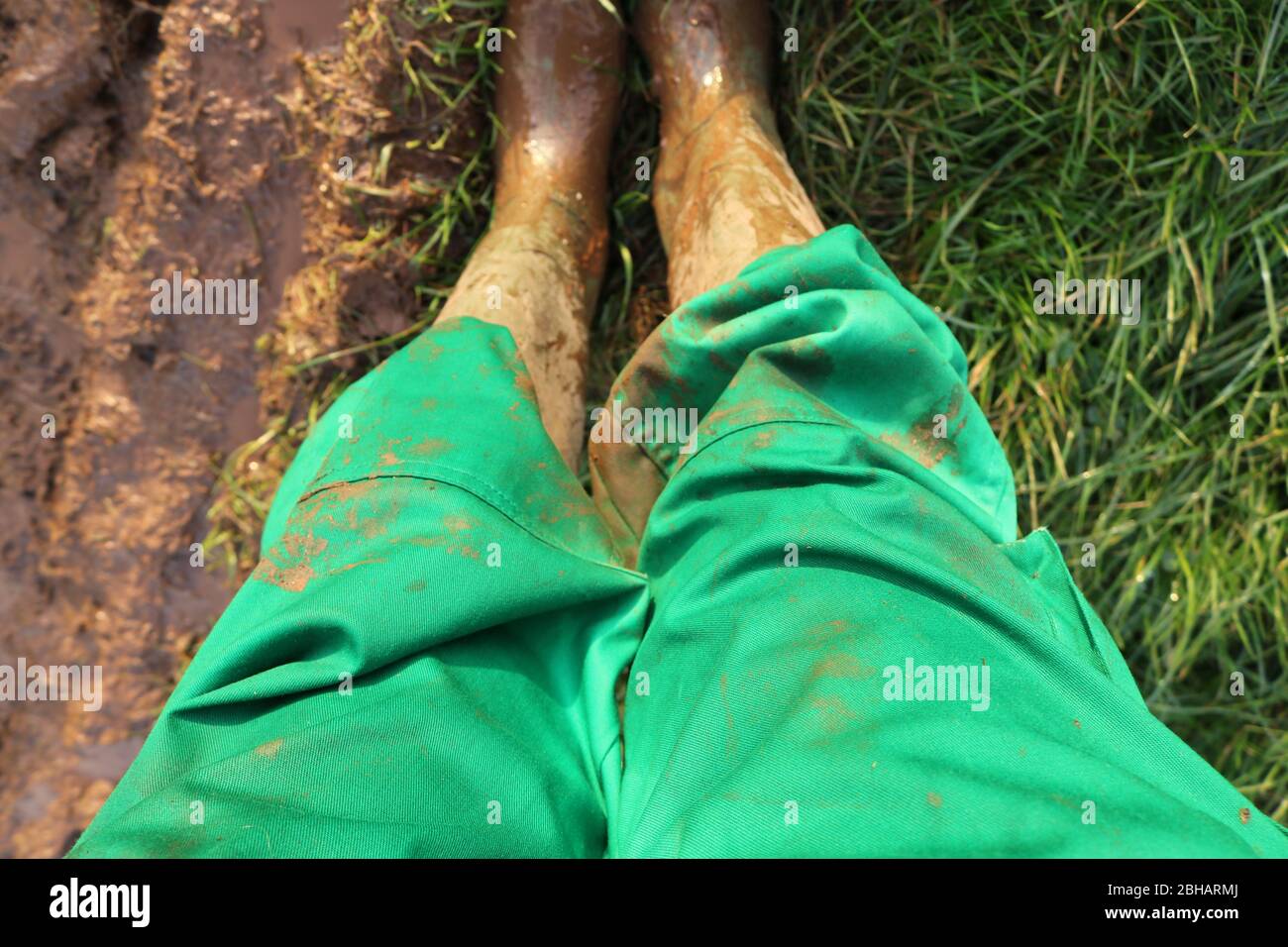 Farmers legs and feet in wellies and overalls in a muddy field Stock ...