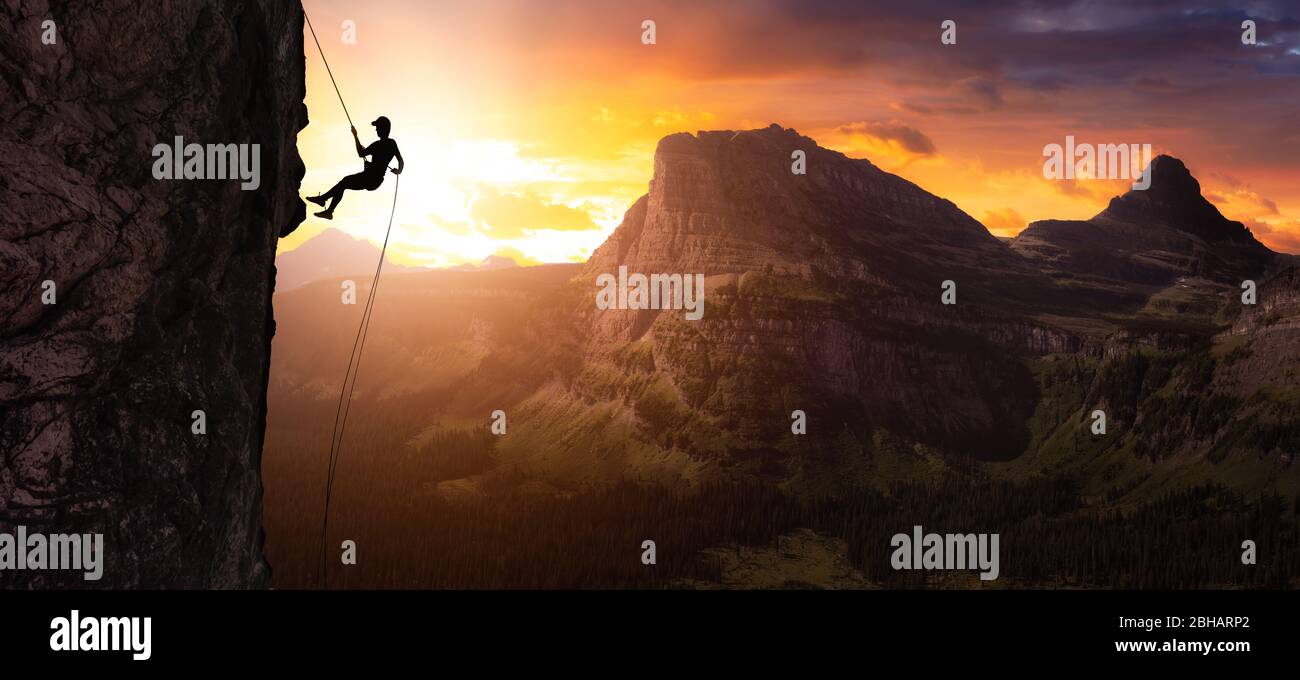 Silhouette Rappelling from Cliff Stock Photo - Alamy