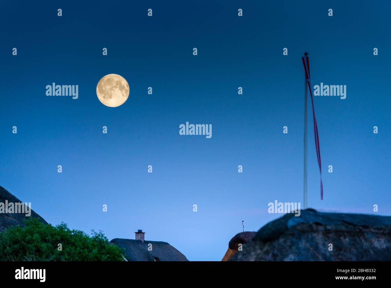Full moon over rooftops with flag hi-res stock photography and images ...