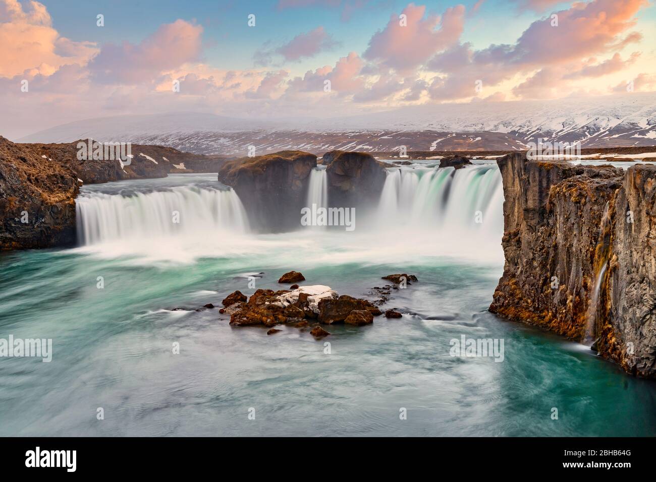 Famous godafoss waterfall in iceland in spring with snowy mountains at ...