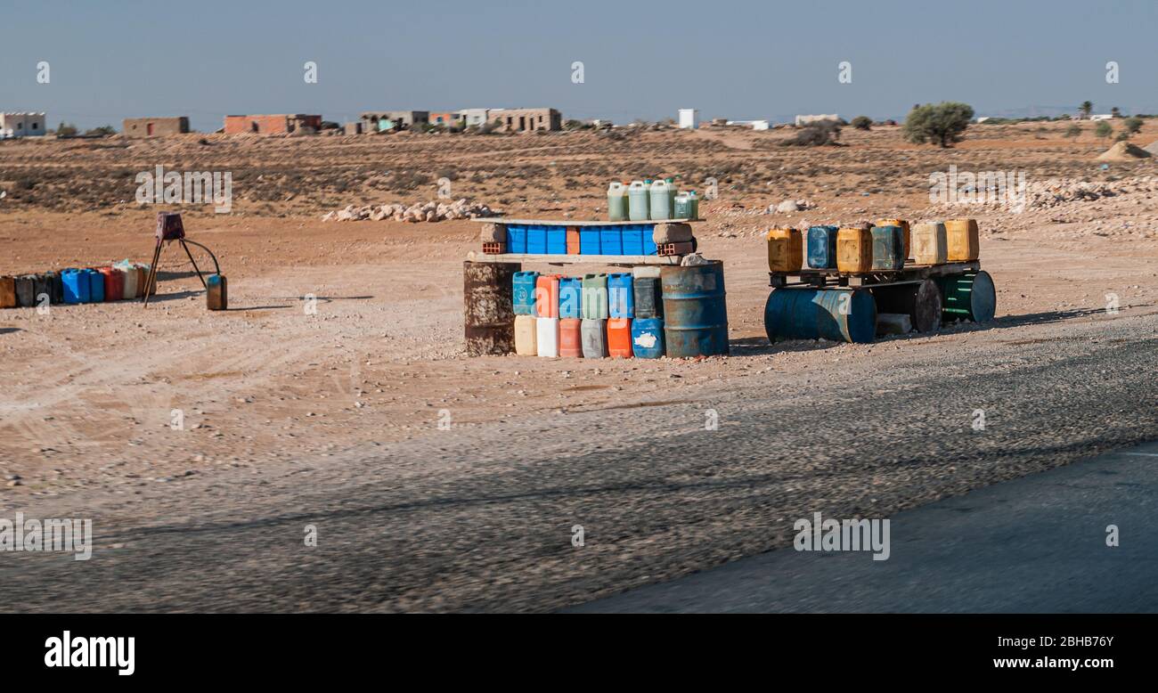 Improvised gas station with tanks of fuel on the road to Sahara desert ...