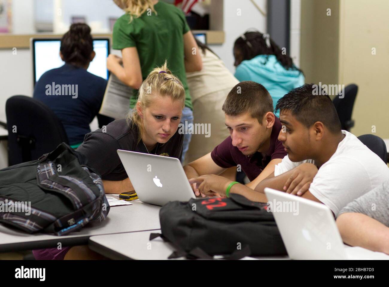 Manor Texas USA, May 11 2010: Teenagers look at an Apple laptop ...