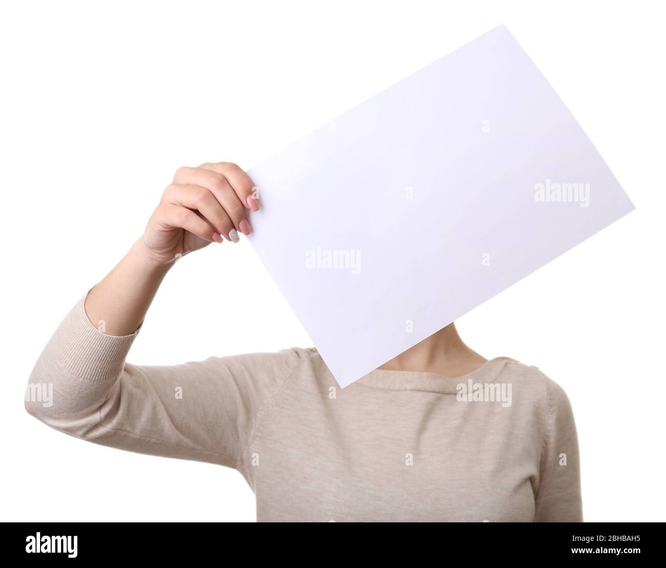 Woman covering her face with blank sheet of paper isolated on white ...