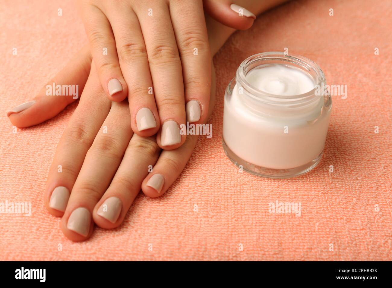 Female hands with jar of cream on fabric background Stock Photo - Alamy