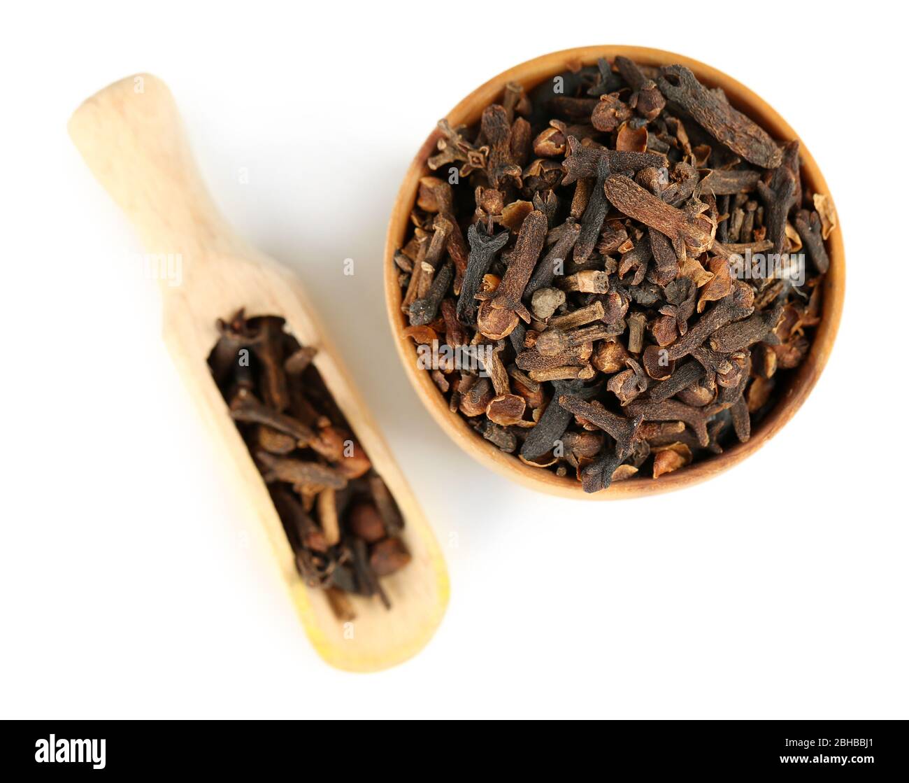 Clove spice in wooden bowl, isolated on white Stock Photo - Alamy