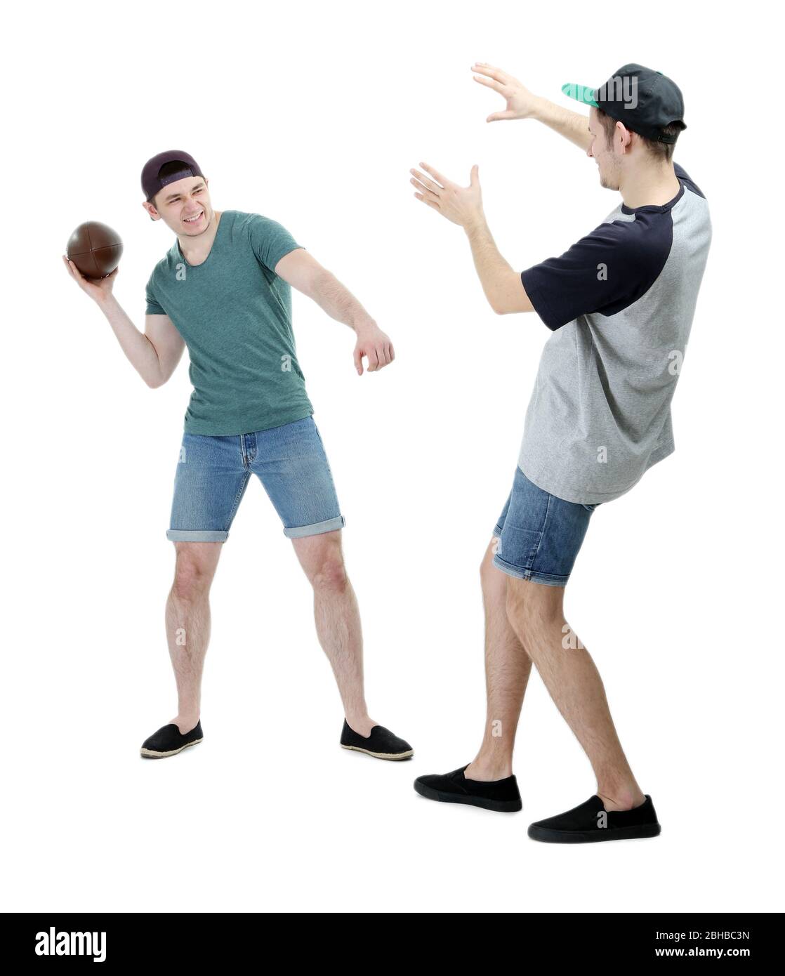 Two handsome young men playing with ball isolated on white Stock Photo ...