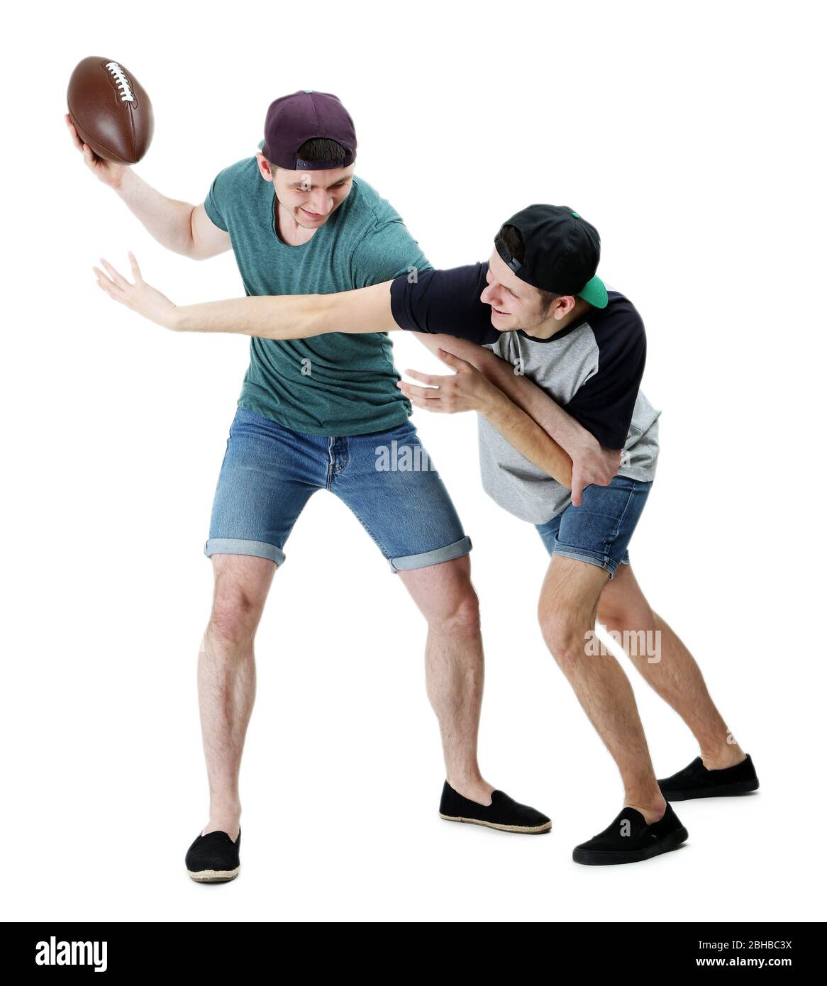 Two handsome young men playing with ball isolated on white Stock Photo ...