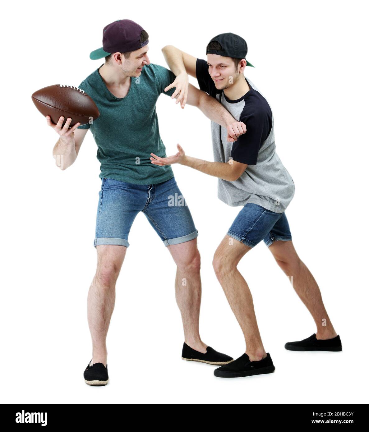 Two handsome young men playing with ball isolated on white Stock Photo ...