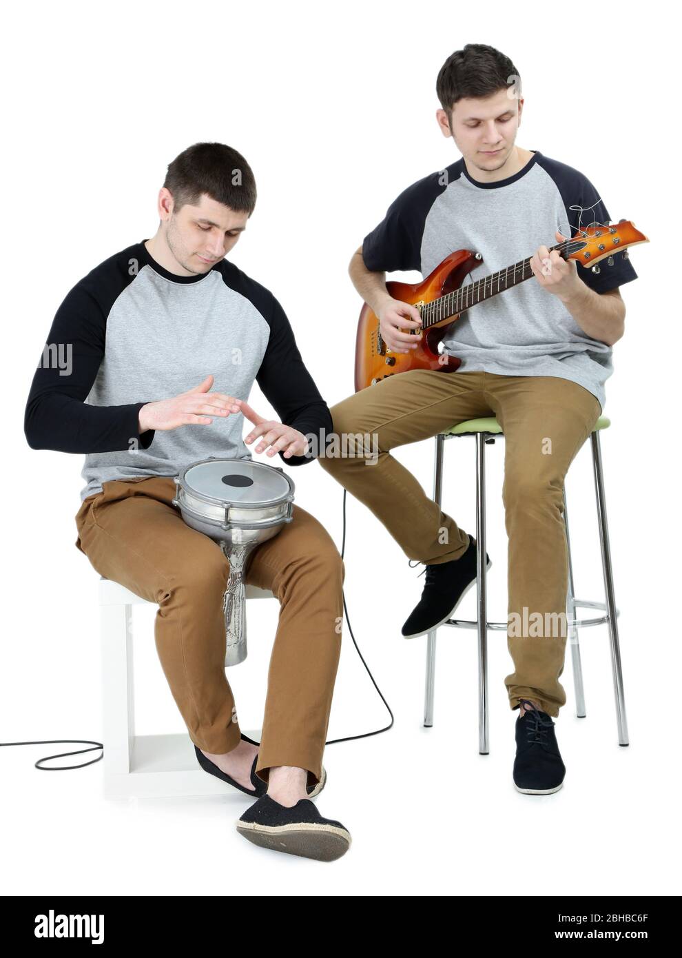 Two handsome young men with musical instruments isolated on white Stock ...