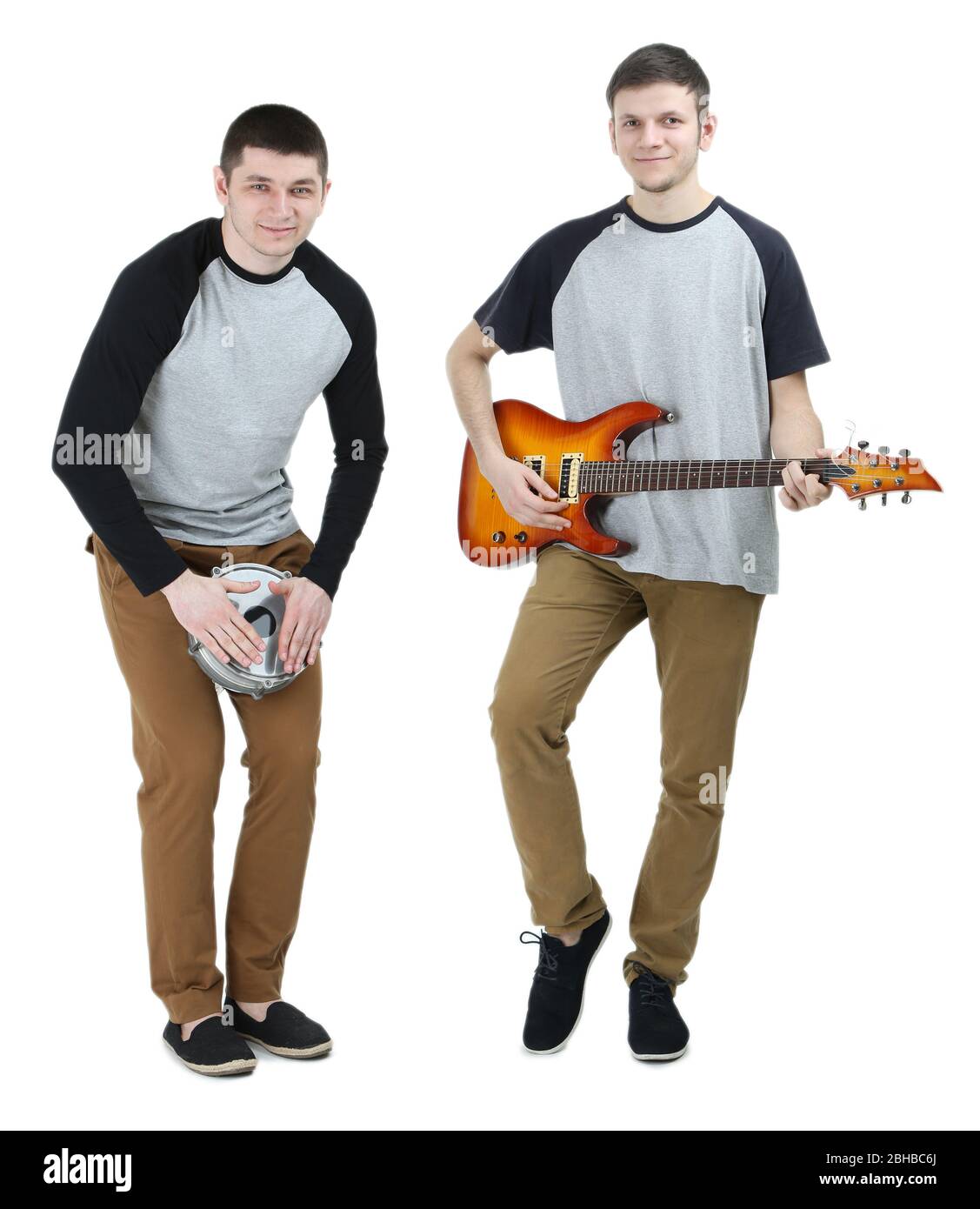 Two handsome young men with musical instruments isolated on white Stock ...