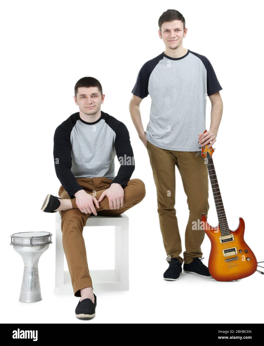 Two handsome young men with musical instruments isolated on white Stock ...