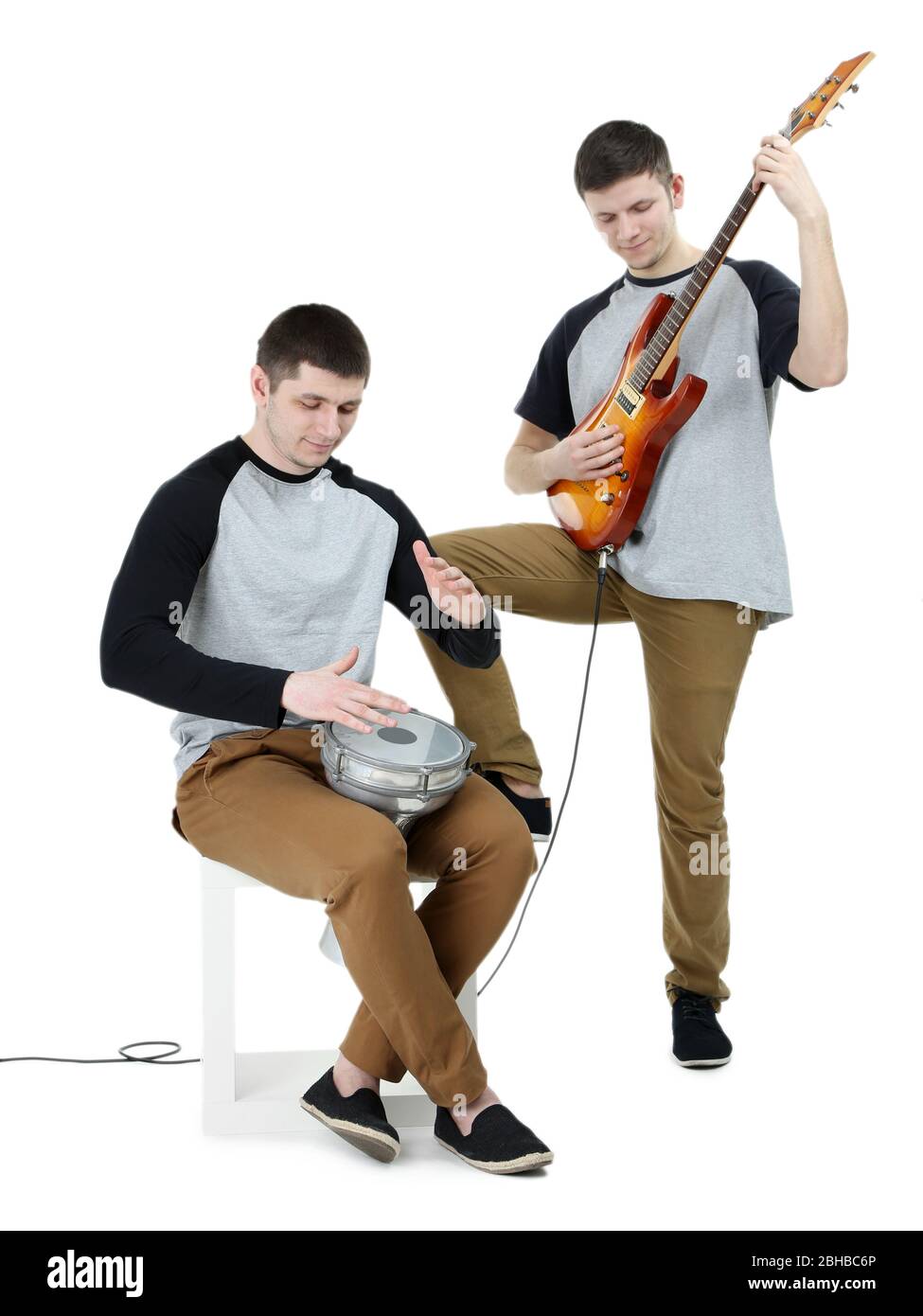 Two handsome young men with musical instruments isolated on white Stock ...