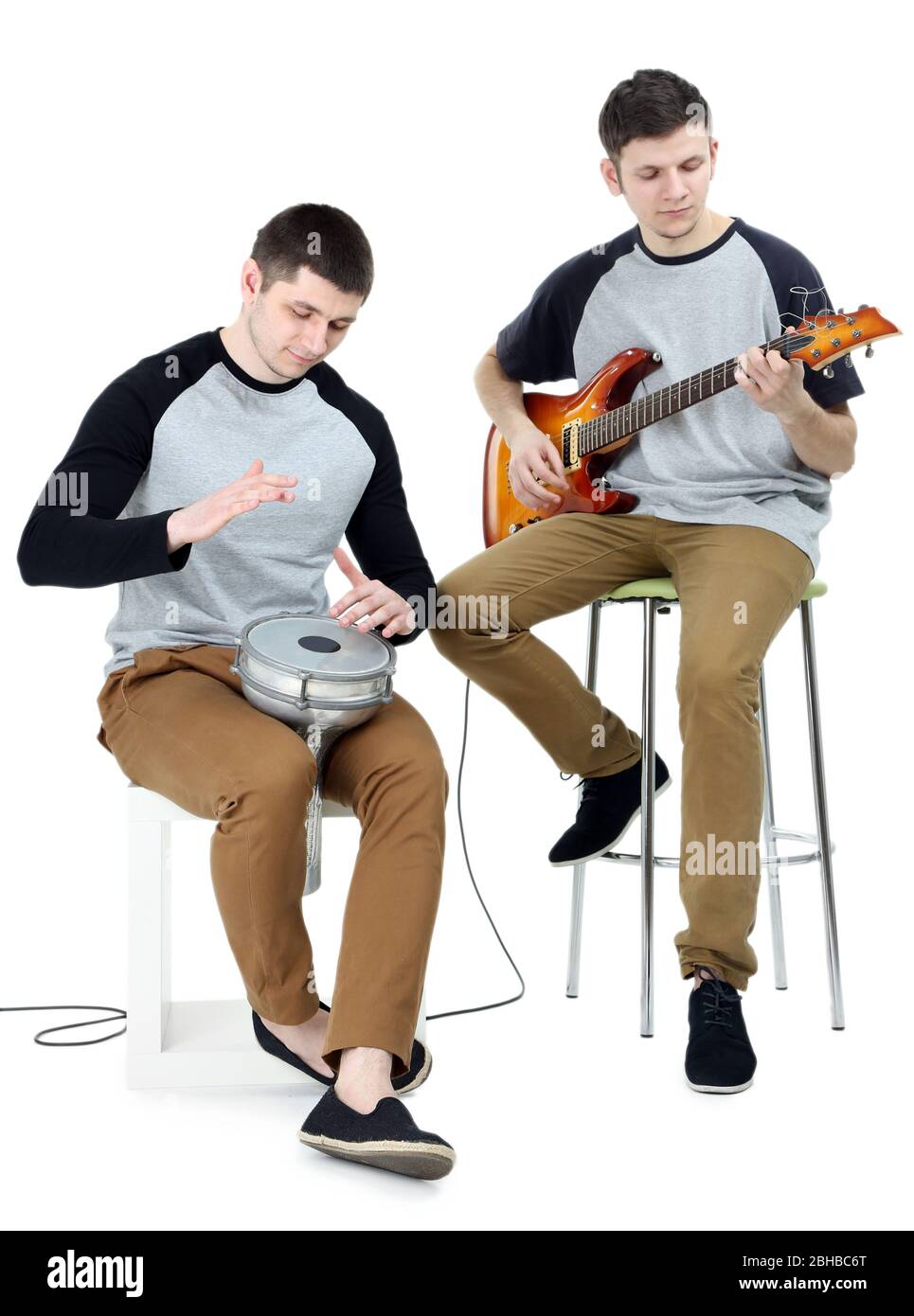 Two handsome young men with musical instruments isolated on white Stock ...