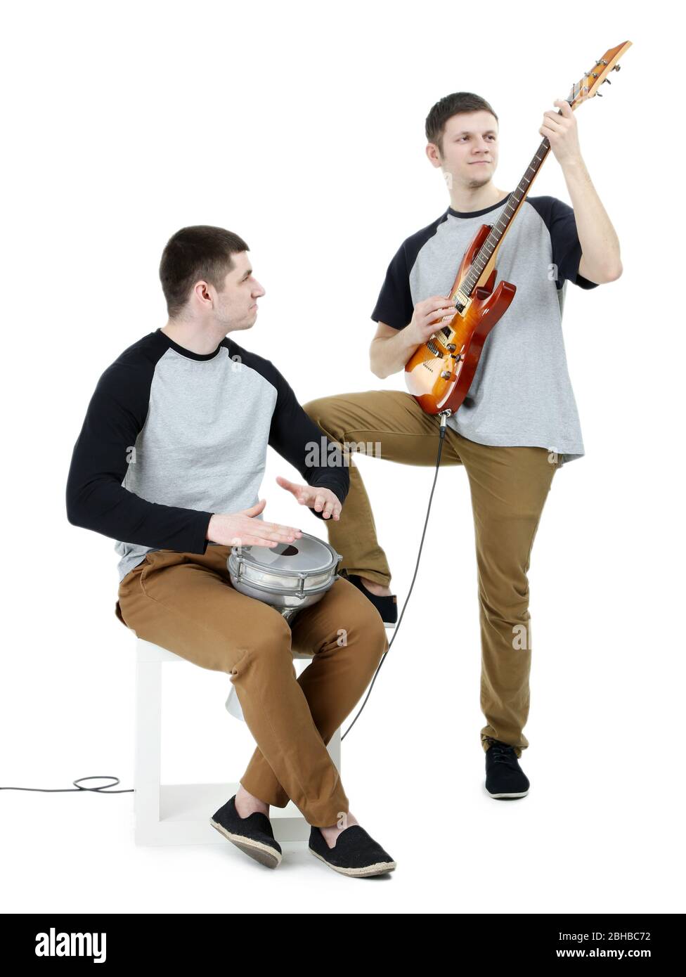 Two handsome young men with musical instruments isolated on white Stock ...