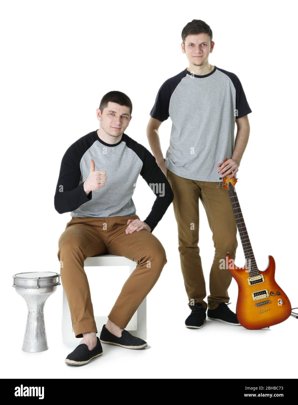 Two handsome young men with musical instruments isolated on white Stock ...