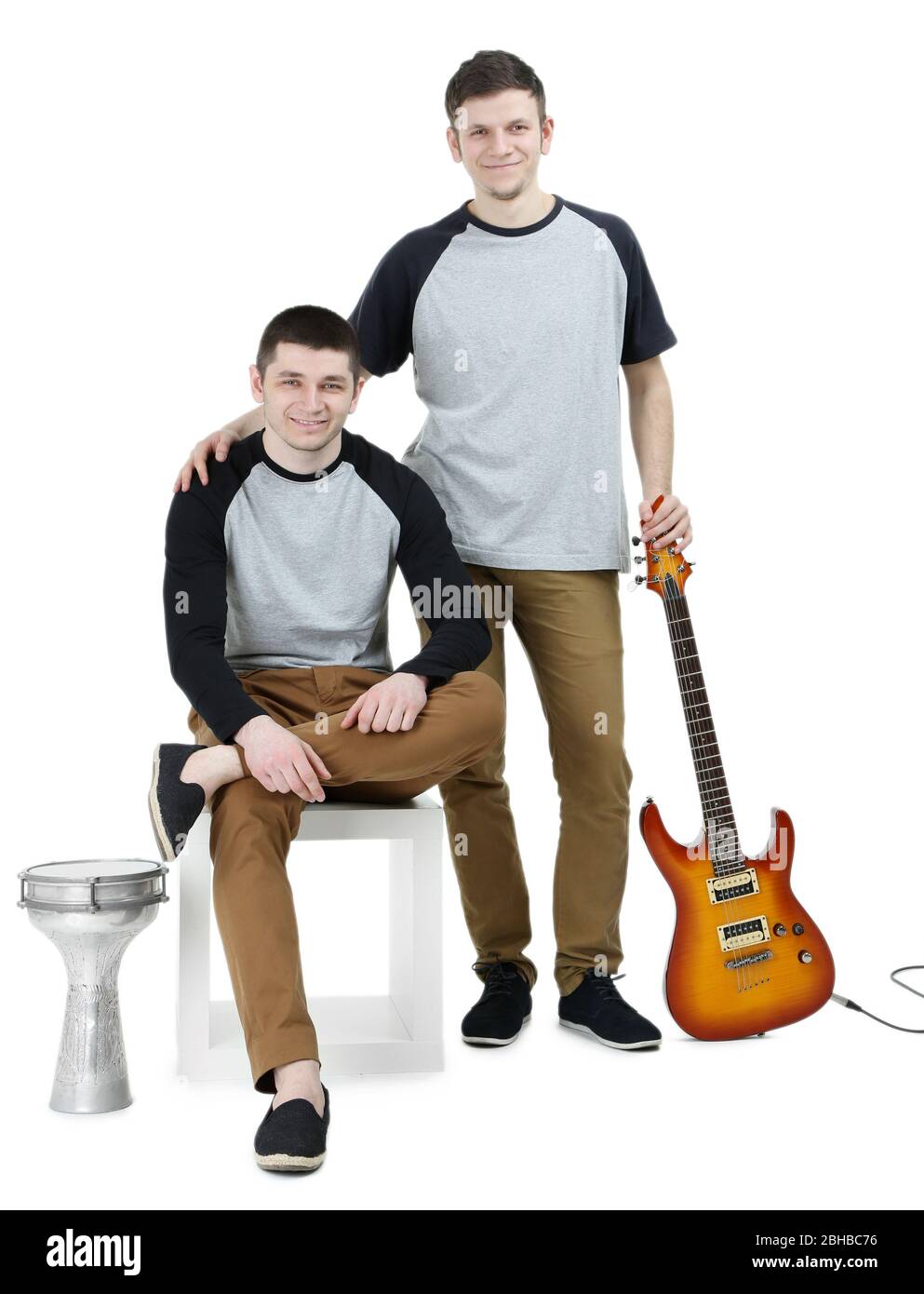 Two handsome young men with musical instruments isolated on white Stock ...