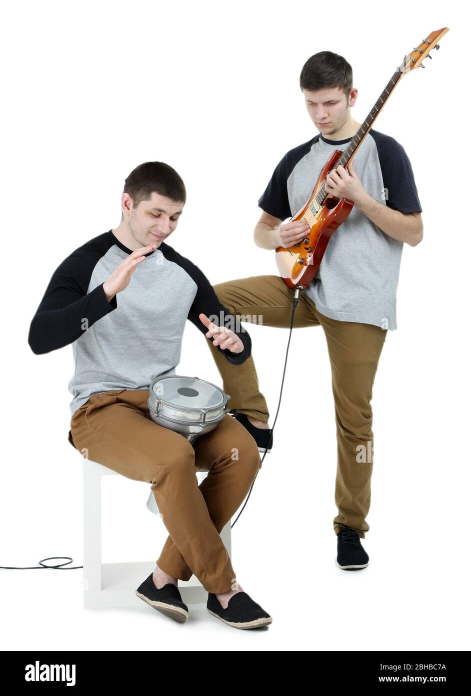 Two handsome young men with musical instruments isolated on white Stock ...