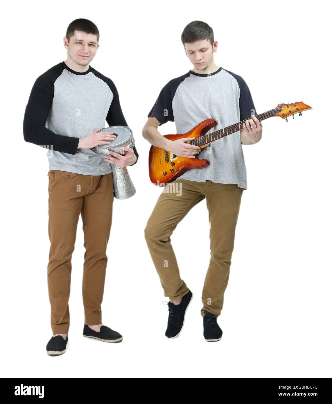 Two handsome young men with musical instruments isolated on white Stock ...