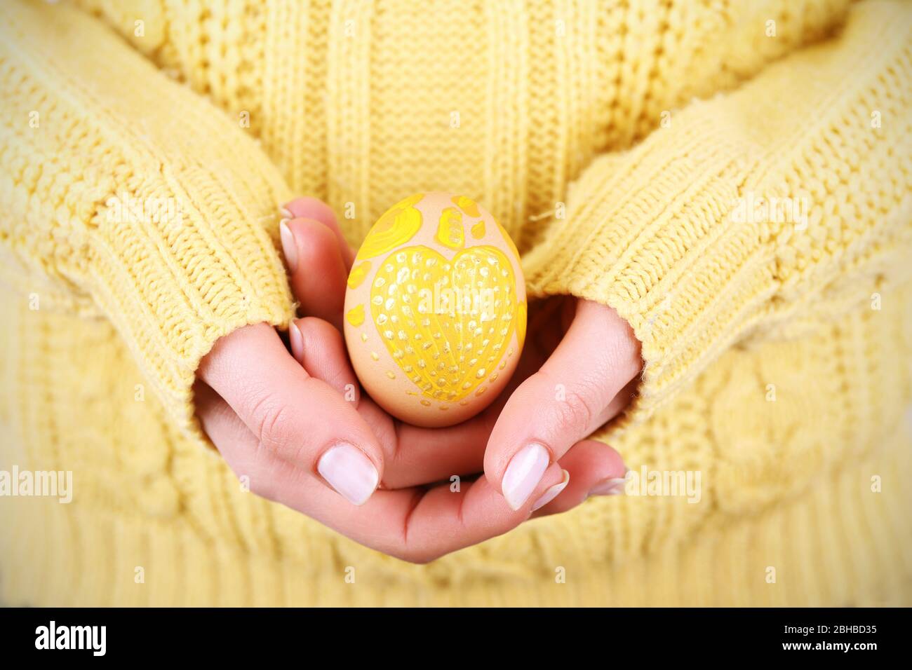 Female hands holding Easter egg, closeup view Stock Photo - Alamy