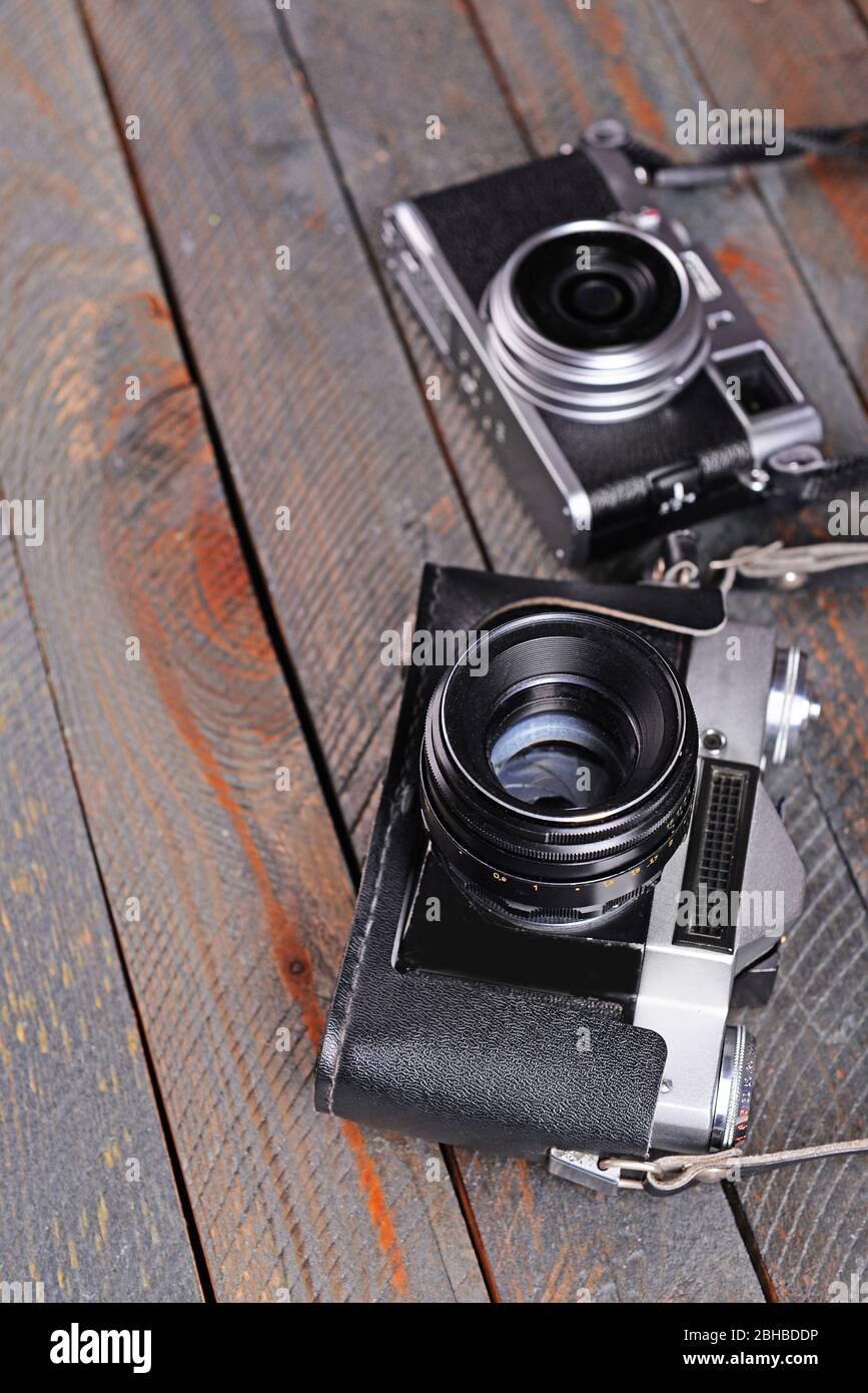 Old retro cameras on rustic wooden planks background Stock Photo - Alamy
