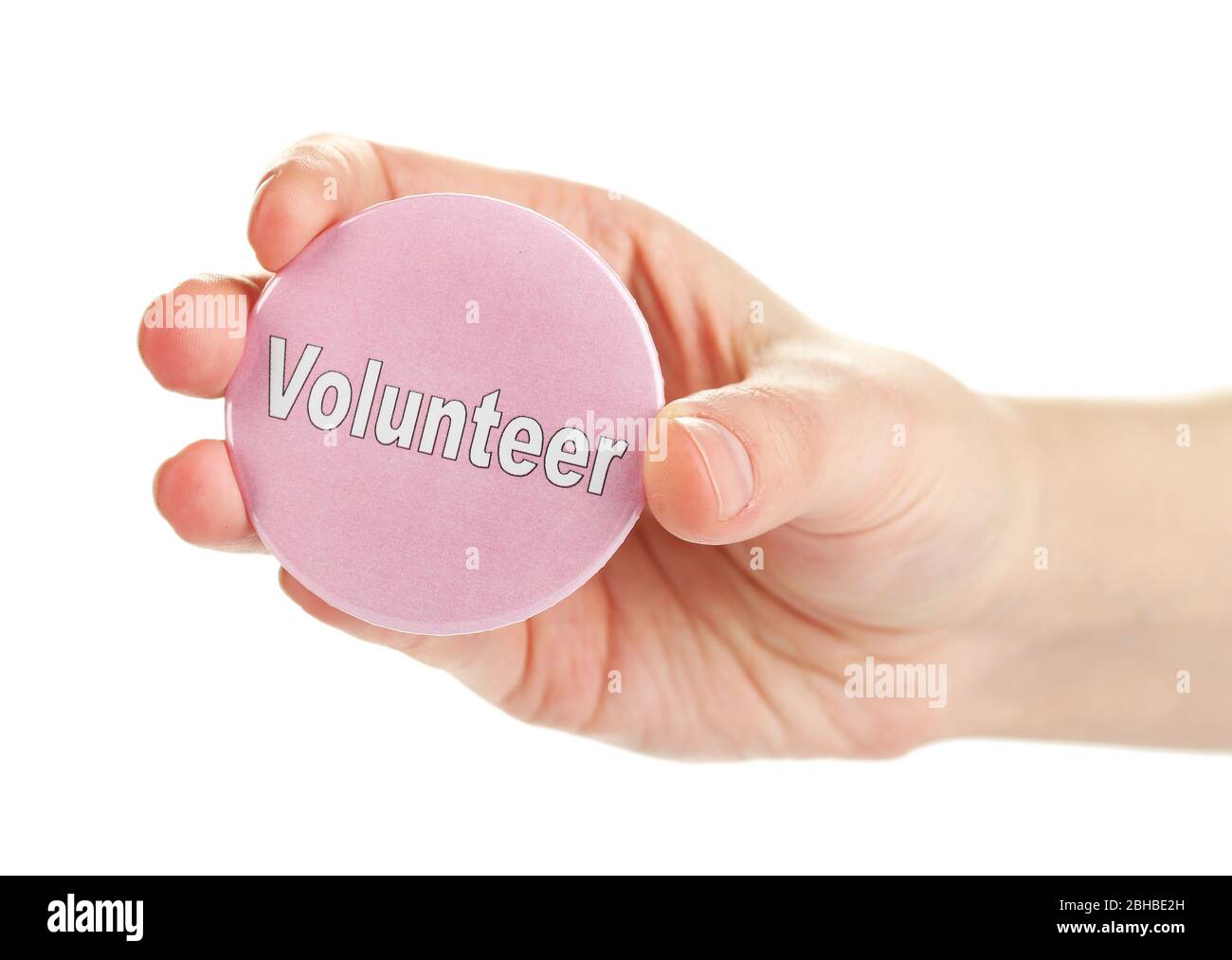 Round volunteer button in hand isolated on white Stock Photo - Alamy
