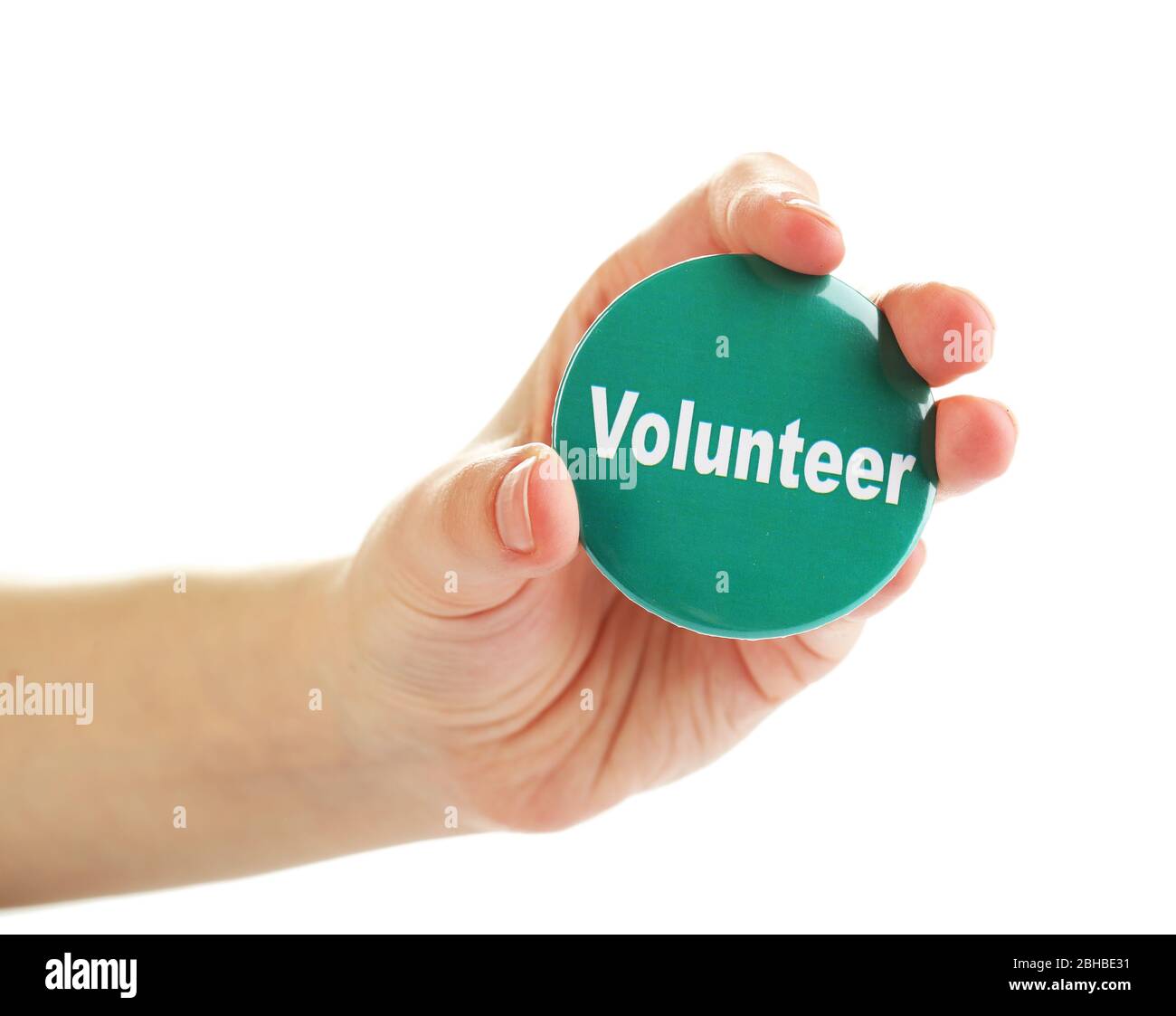 Round volunteer button in hand isolated on white Stock Photo - Alamy