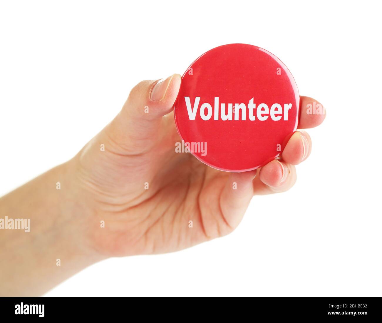 Round volunteer button in hand isolated on white Stock Photo - Alamy