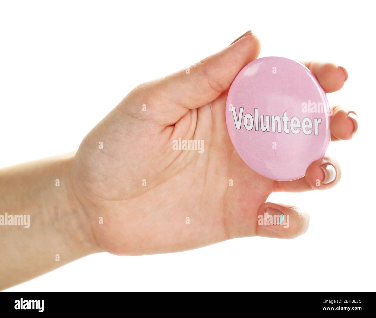 Round volunteer button in hand isolated on white Stock Photo - Alamy