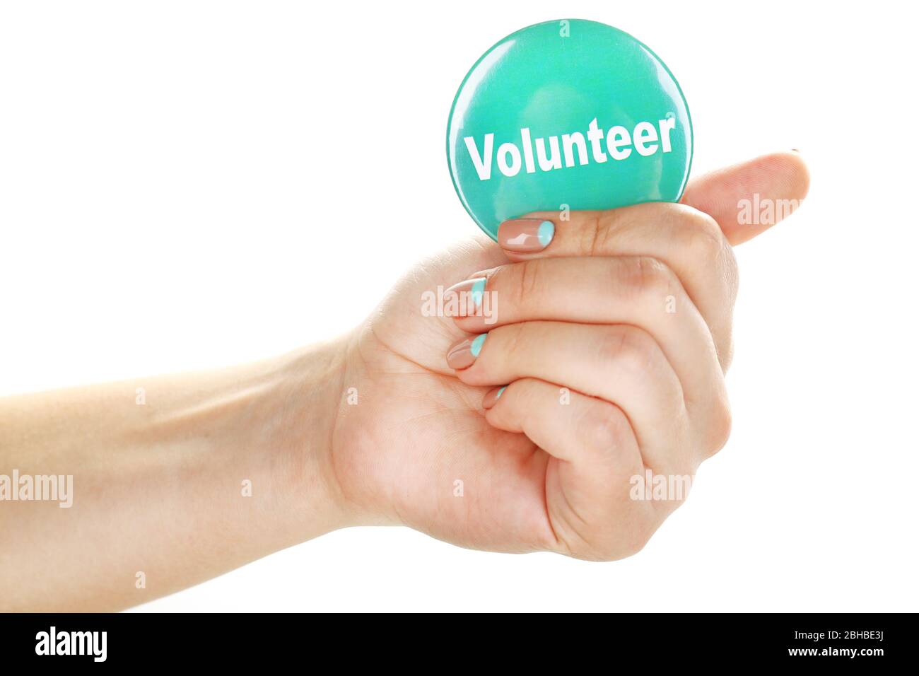 Round volunteer button in hand isolated on white Stock Photo - Alamy