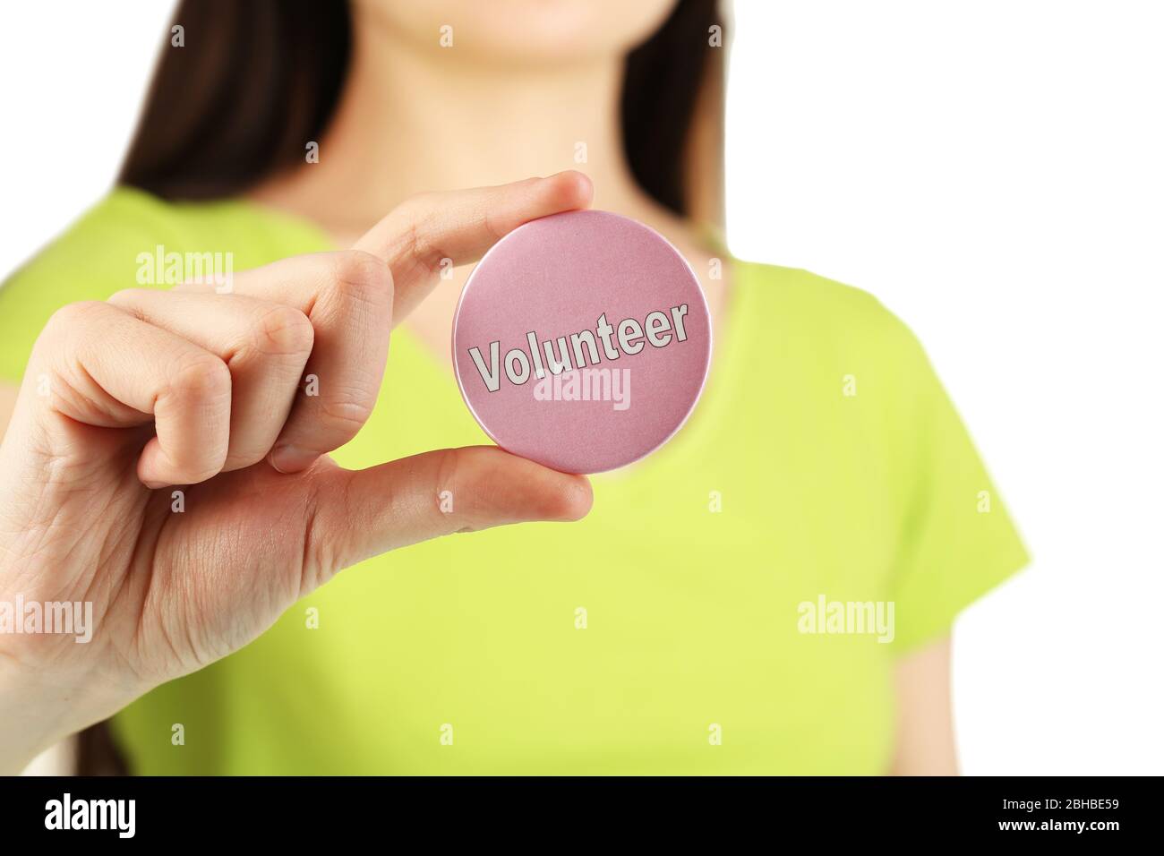 Round volunteer button in hand of girl isolated on white Stock Photo ...