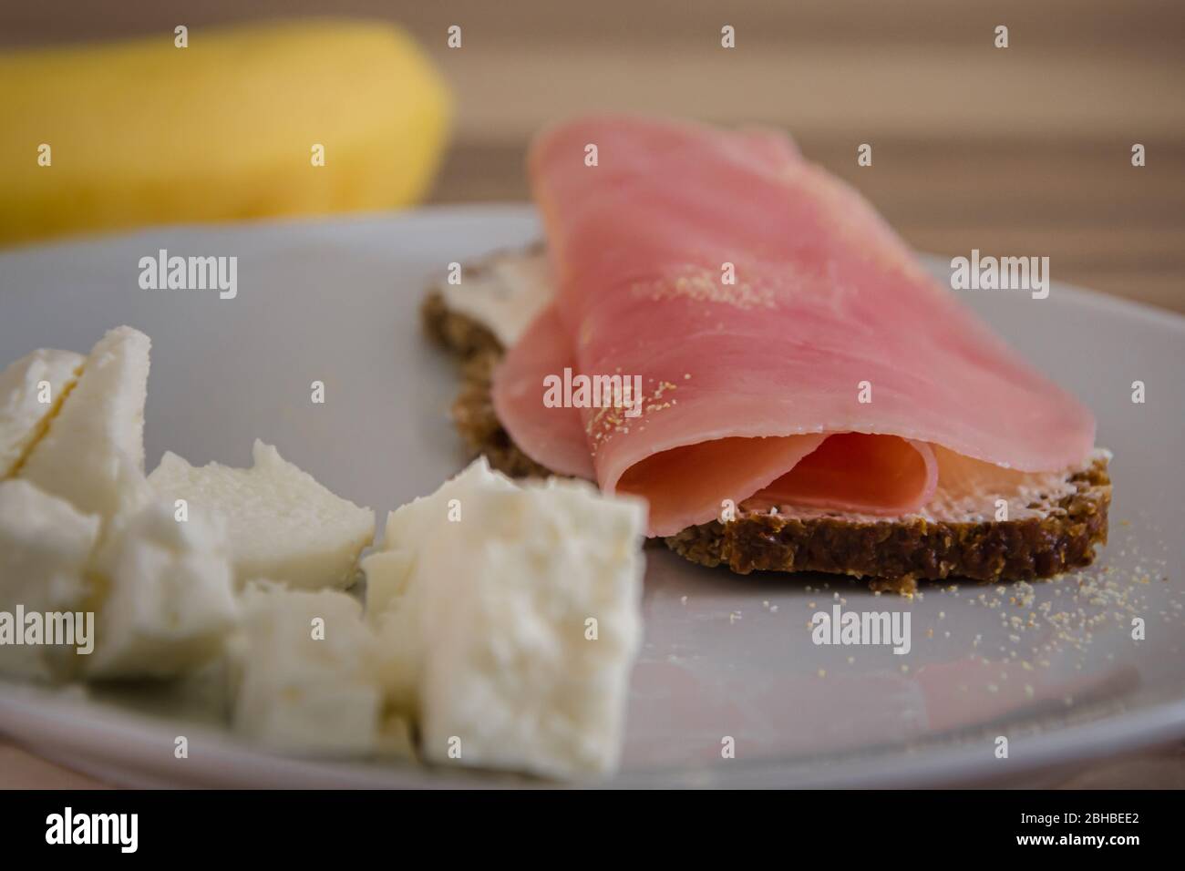 A healthy plate of low-fat ham with spices on wholemeal bread and white ...