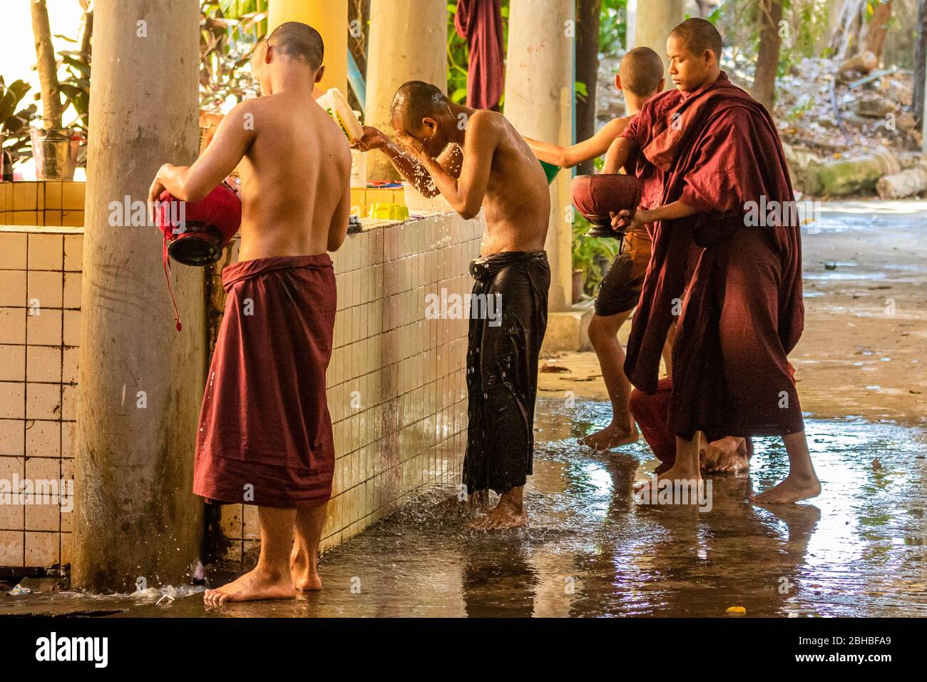 Young monks bathing in the morning Stock Photo - Alamy