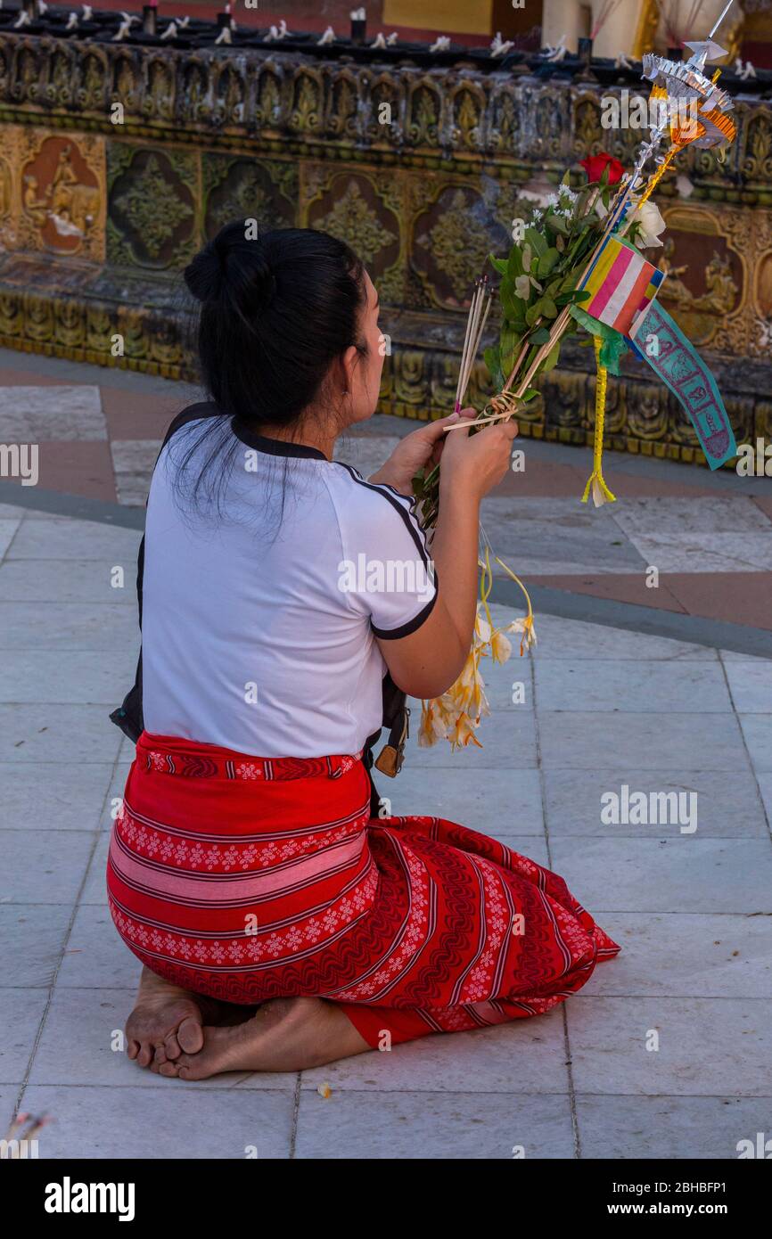 Young Burmese woman praying in front of Shwedagon Pagoda in Yangon ...