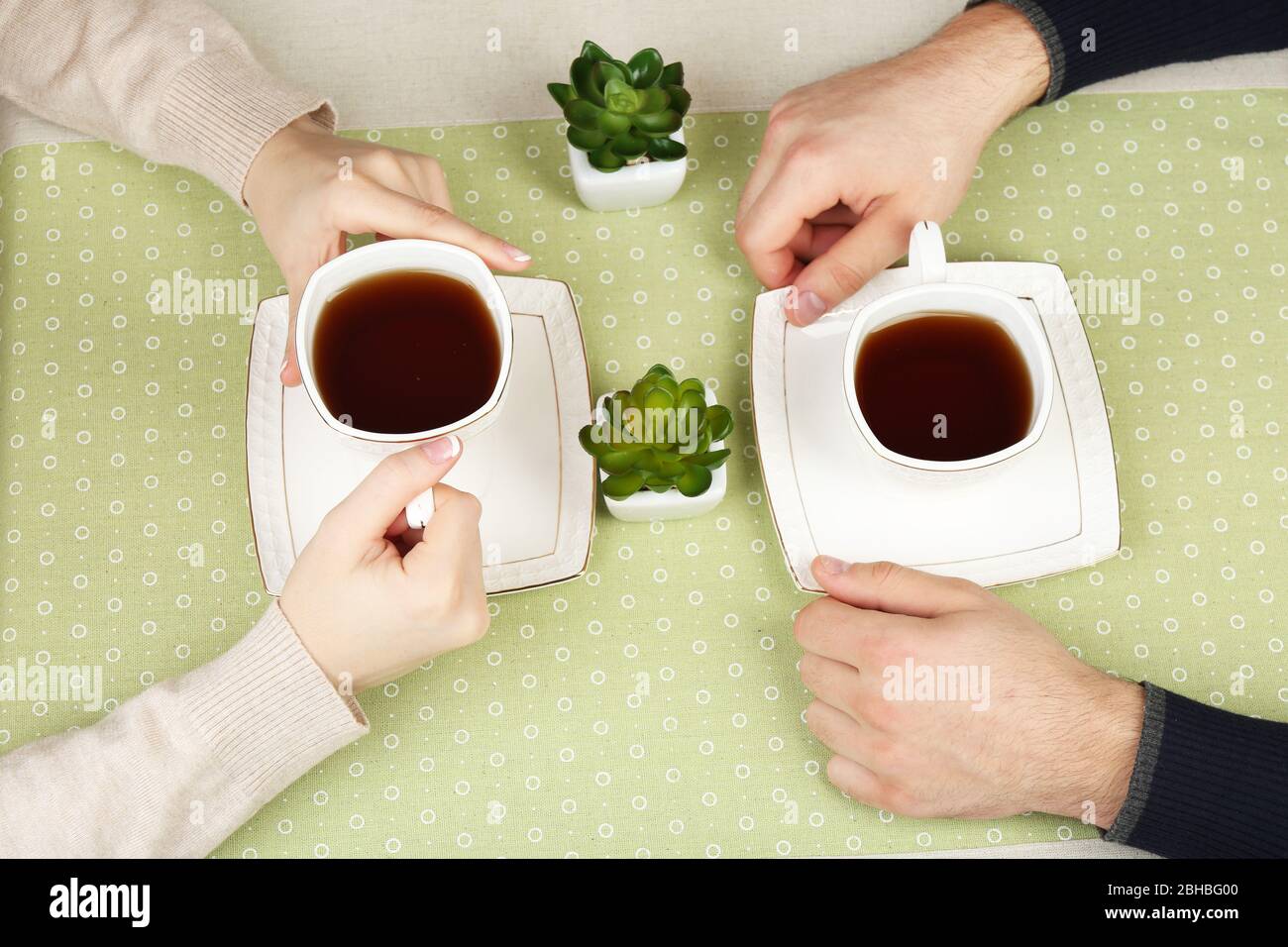 Female and male hands with cups of tea, close-up Stock Photo - Alamy
