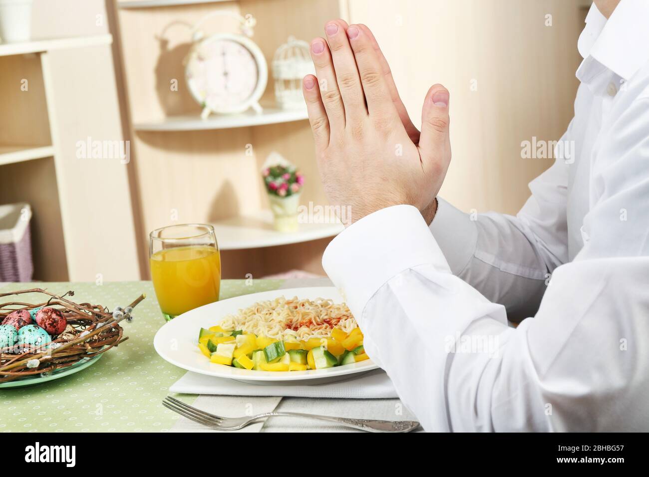 Man praying before eating Stock Photo - Alamy