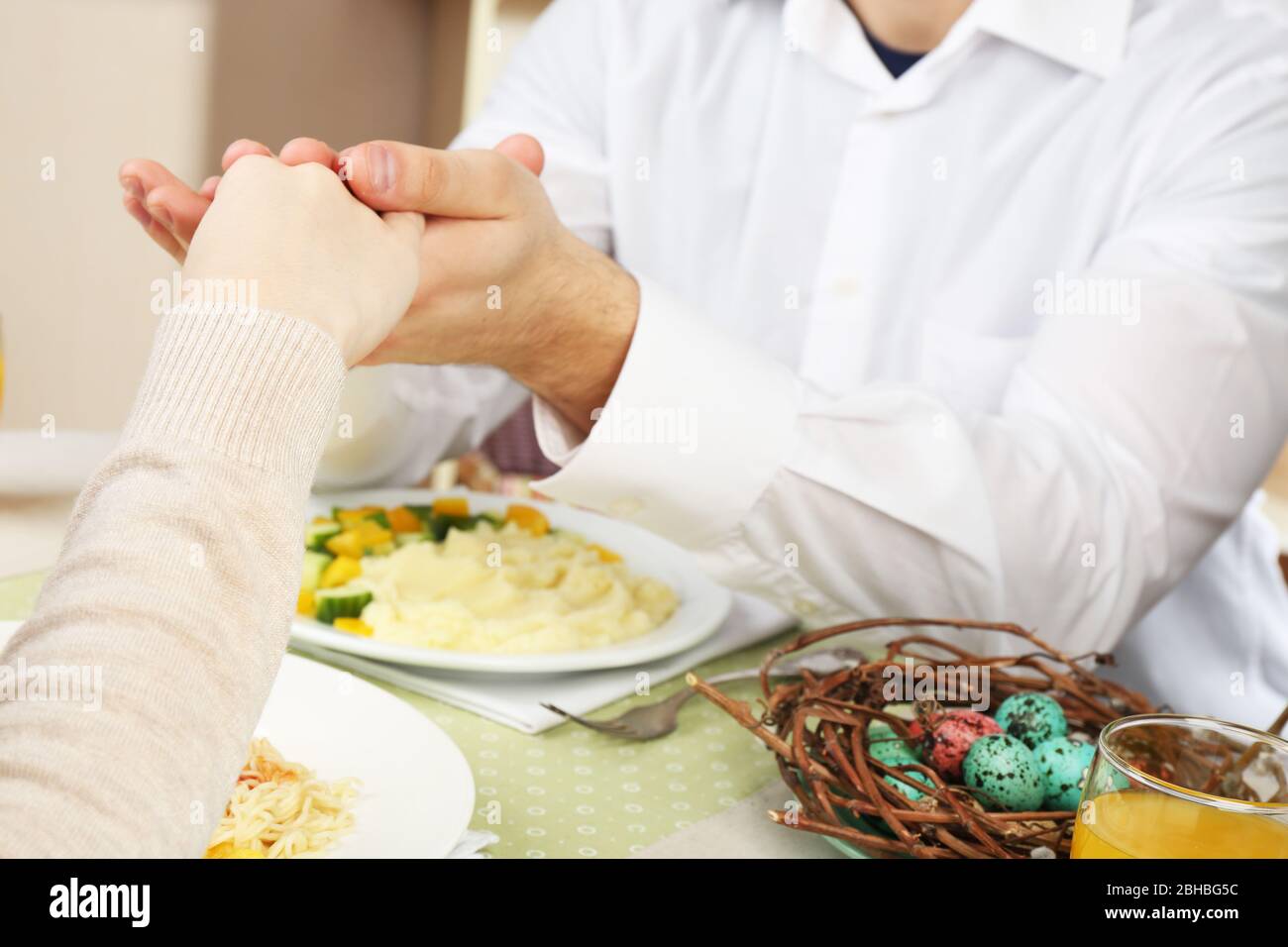 People praying before eating Stock Photo - Alamy