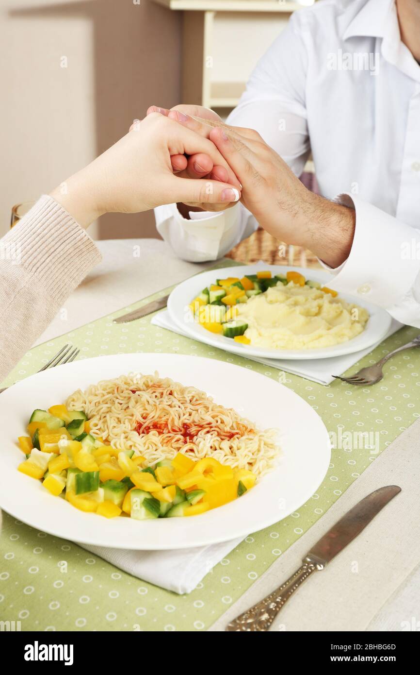 People praying before eating Stock Photo - Alamy