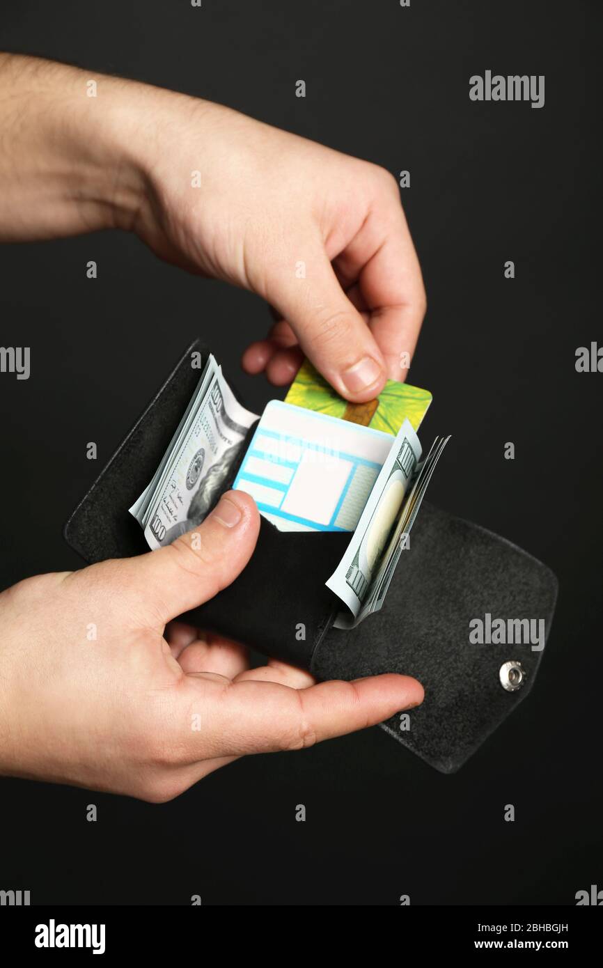 Man holding hand made leather wallet with money Stock Photo - Alamy