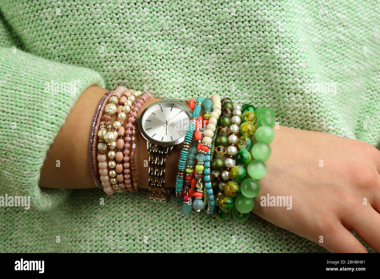 Stylish bracelets and clock on female hand close-up Stock Photo - Alamy