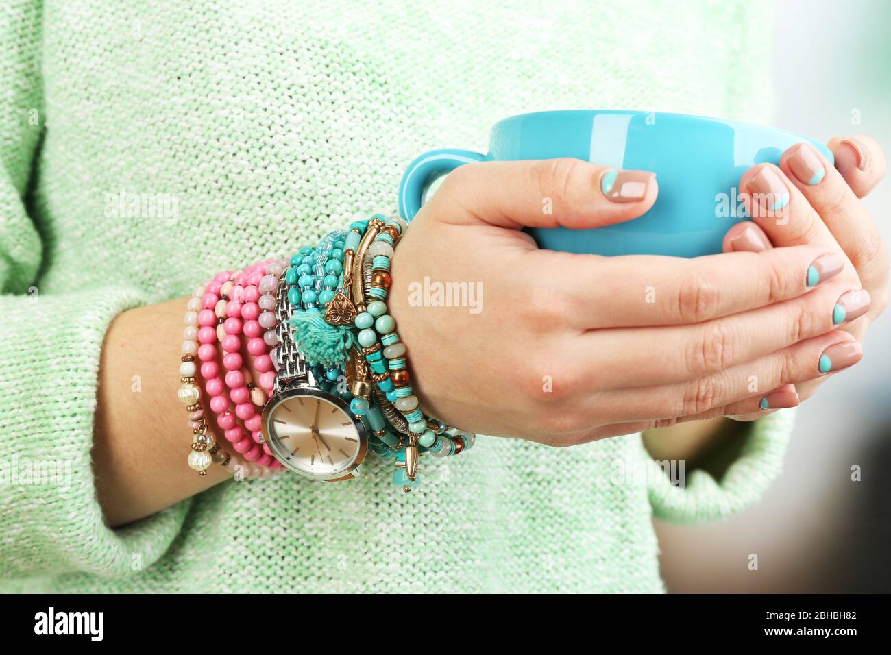 Stylish bracelets and clock on female hand close-up Stock Photo - Alamy