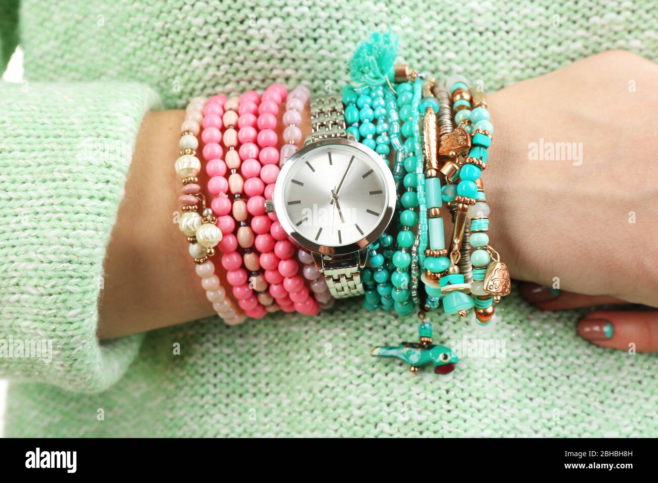 Stylish bracelets and clock on female hand close-up Stock Photo - Alamy