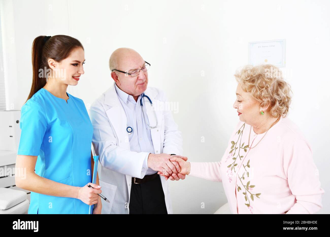 Happy doctors and patients in hospital clinic Stock Photo - Alamy